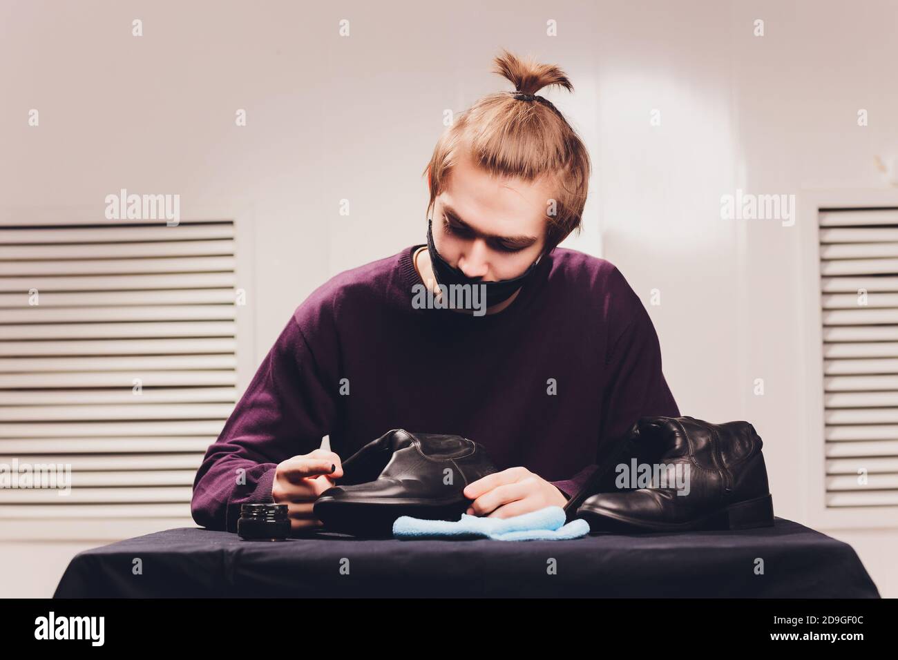 boots. applying cream with your finger. Shoe repair Stock Photo - Alamy