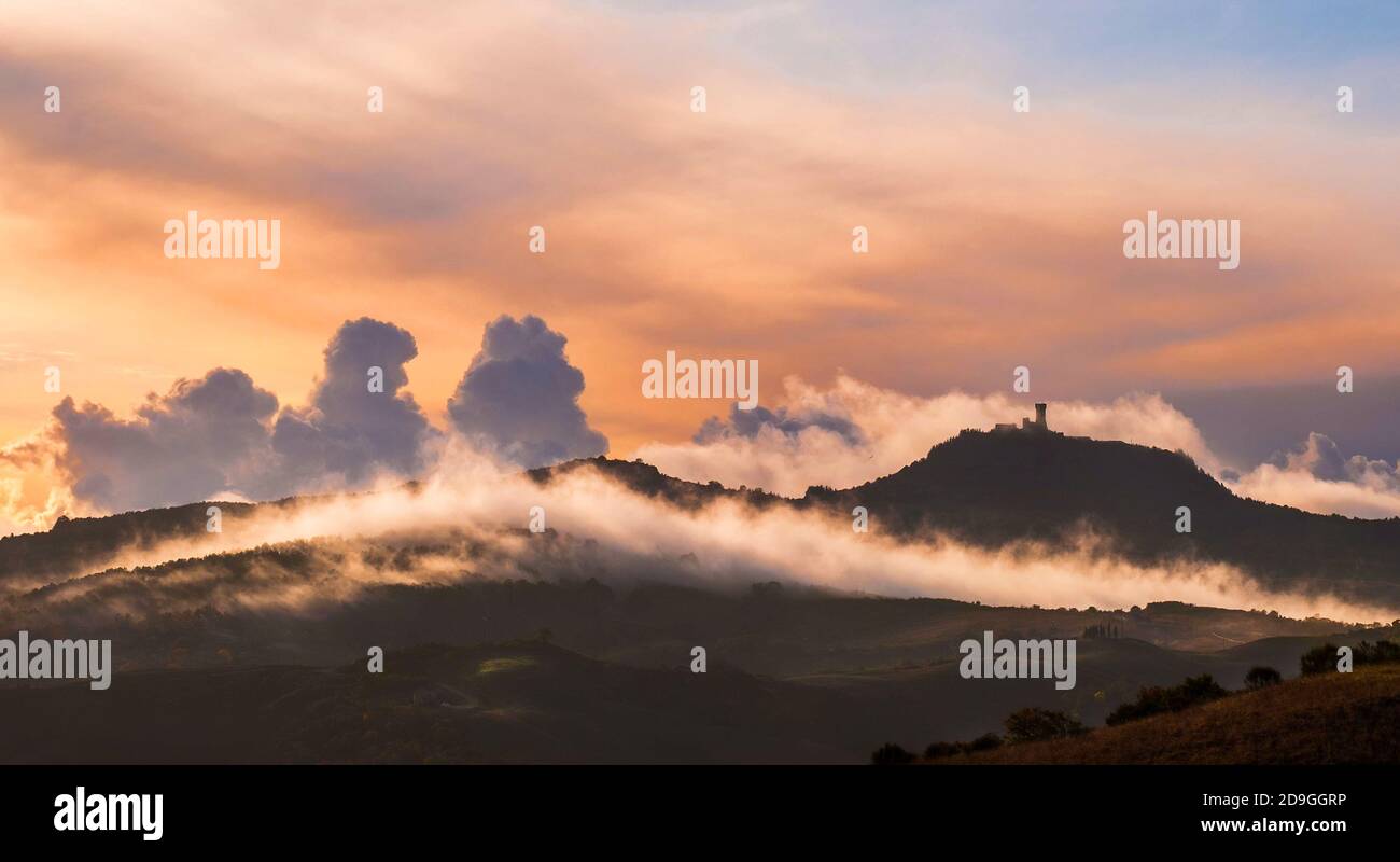 Rocca di Radicofani main tower fortification covered with morning mist ...