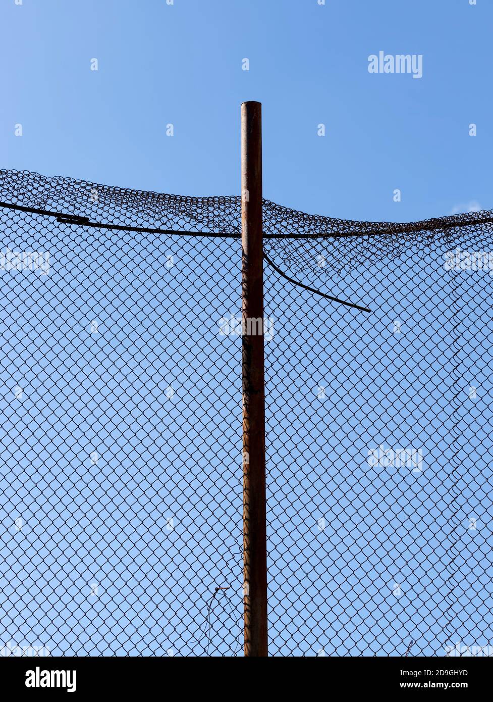 old wire fence made of thin wire against the blue sky Stock Photo - Alamy