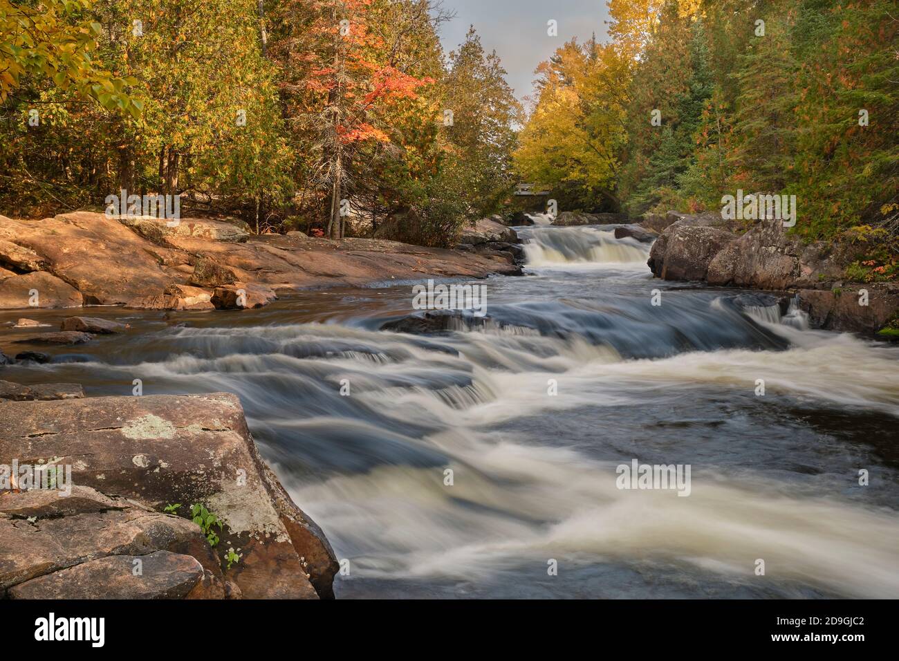 Surrounded by granite rocks, water cascades down a number of small ...
