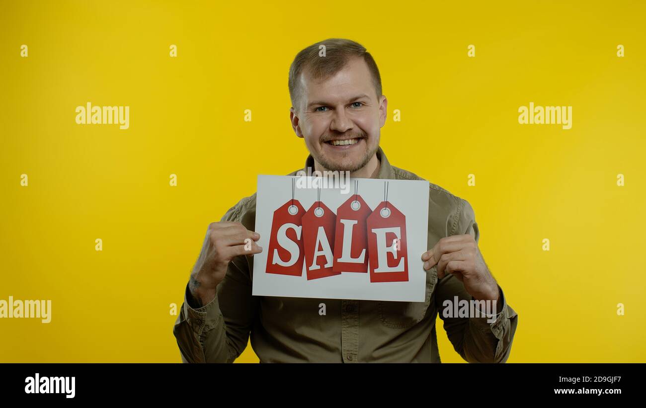 Cheerful man showing sale word hi-res stock photography and images - Alamy