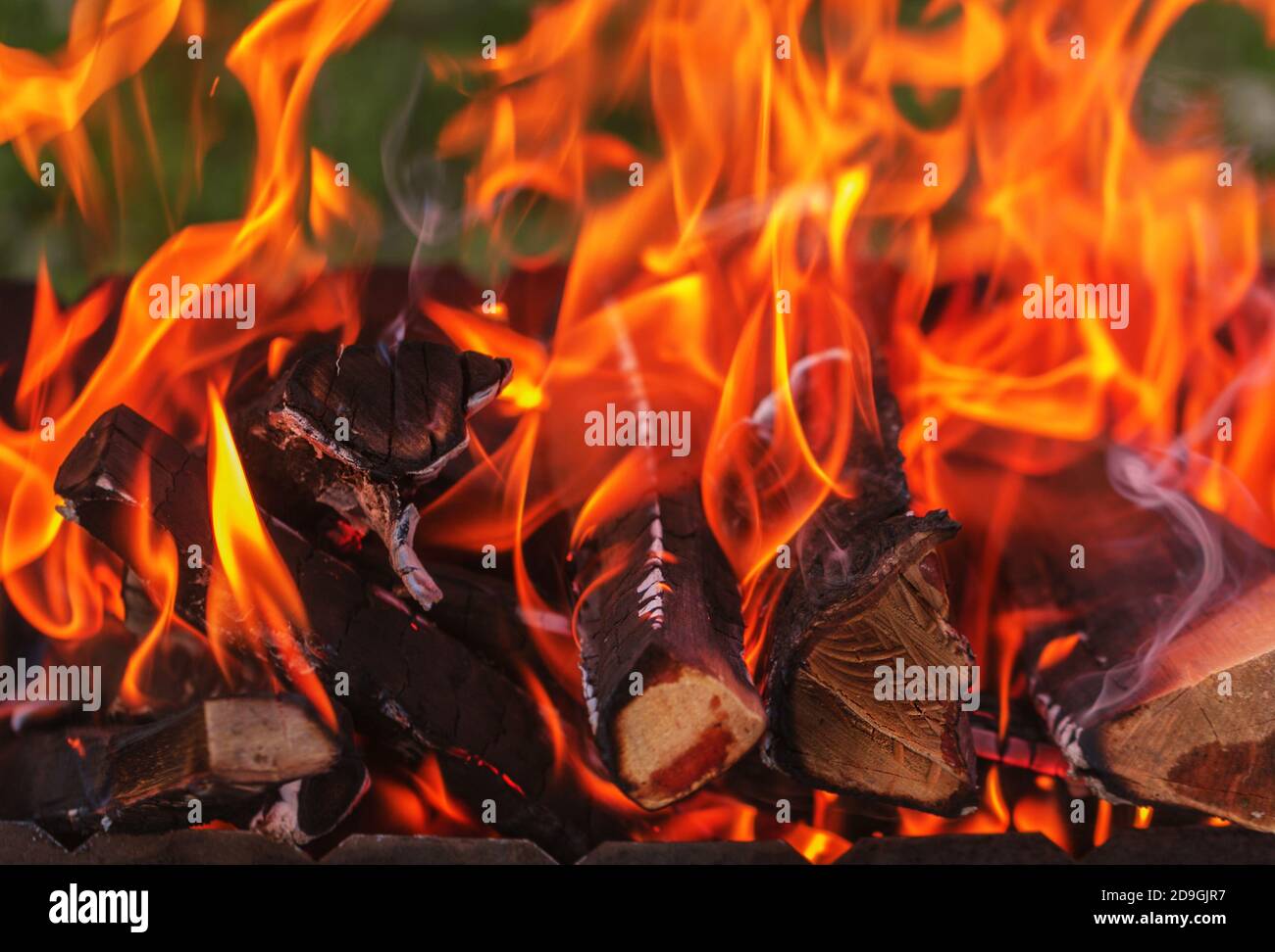 Wooden logs in bright fire for better cozy time Stock Photo - Alamy