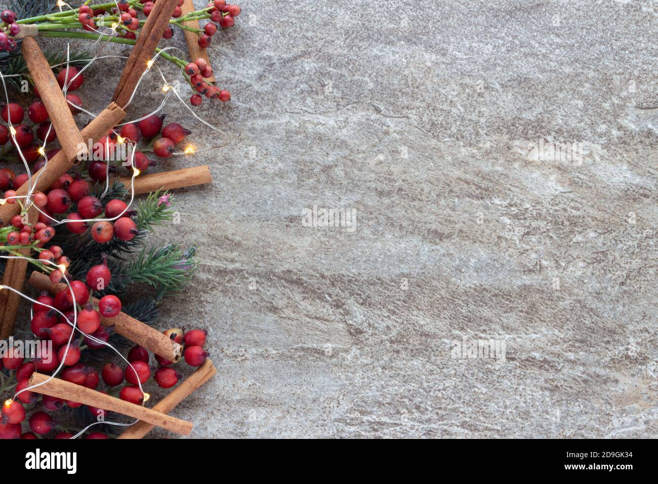 Christmas background with copy space, berries, cinnamon sticks ...