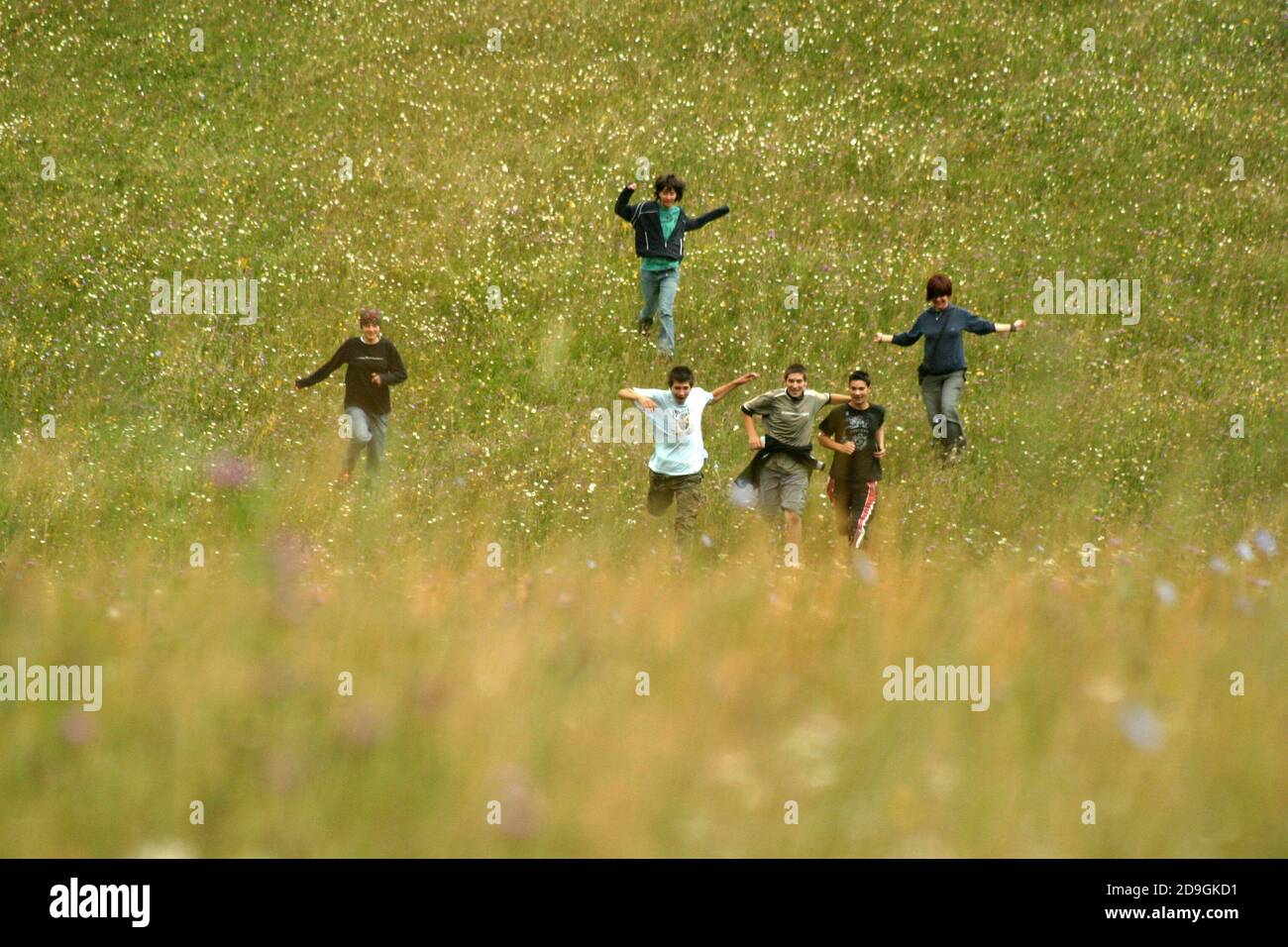 Group running through meadow hi-res stock photography and images - Alamy