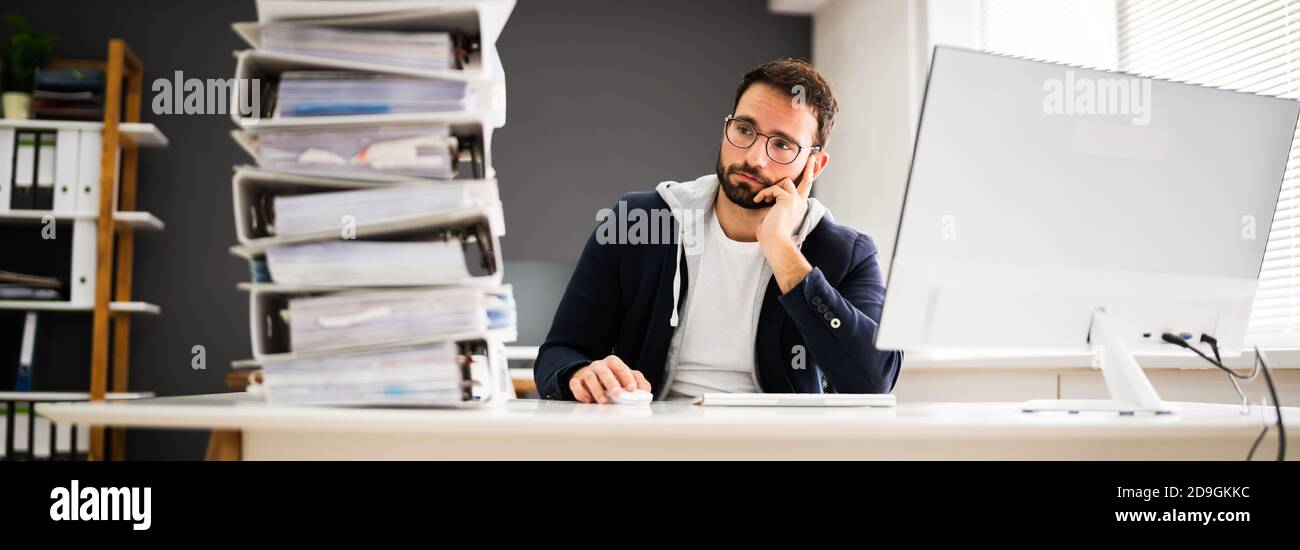 Sad Professional Man In Office Using Computer Stock Photo - Alamy