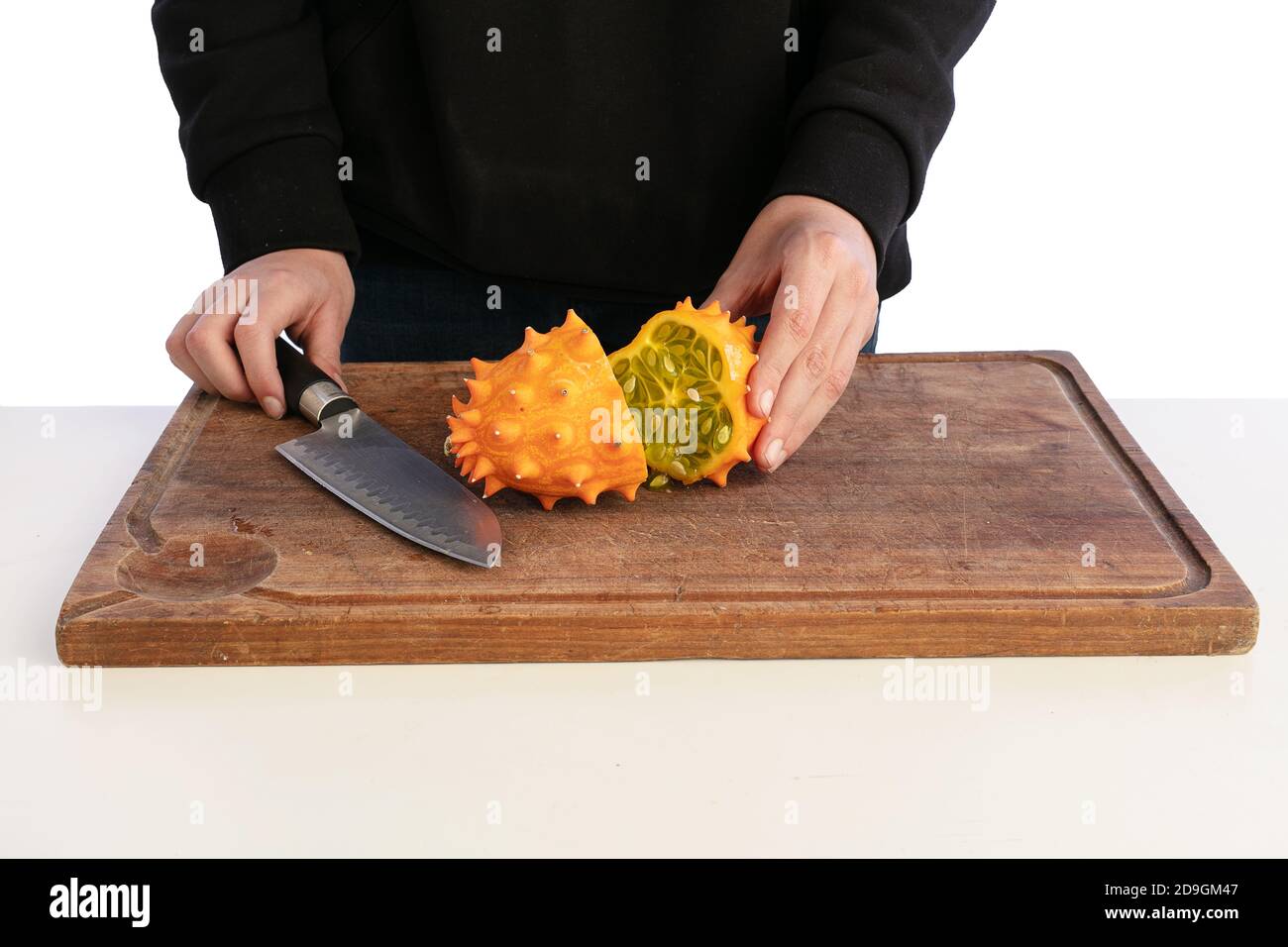 hands that cut Kiwano on a white background Stock Photo - Alamy