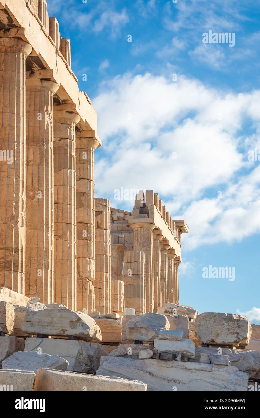 Doric columns of the Parthenon against a blue sky with clouds ...