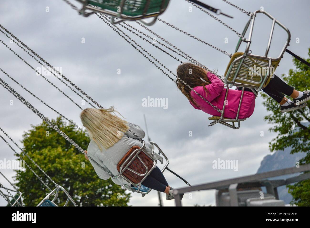 Females enjoying the ride in an amusement park during the daytime Stock ...