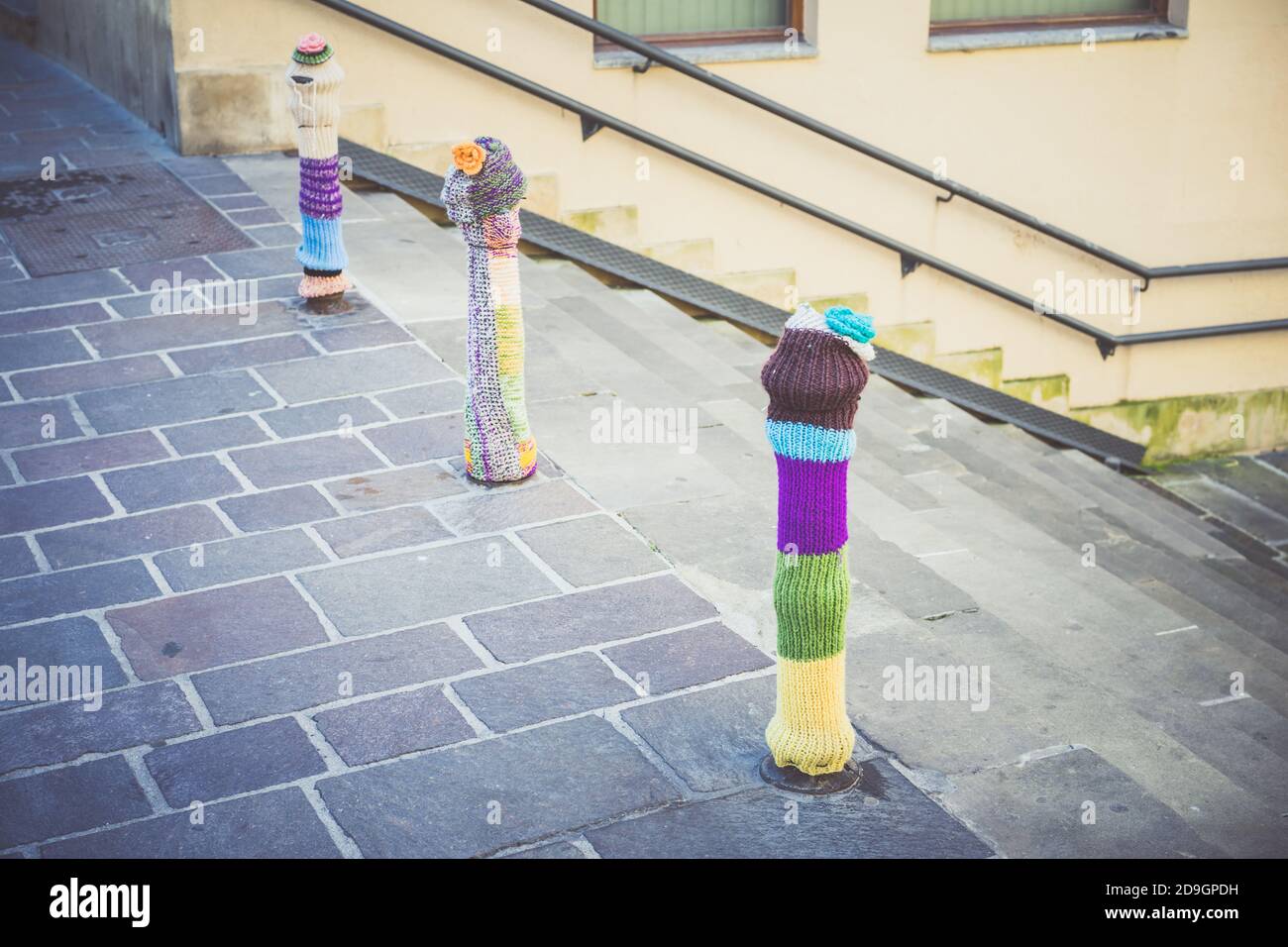 Decorated poles with colorful knitted socks on stairs Stock Photo - Alamy