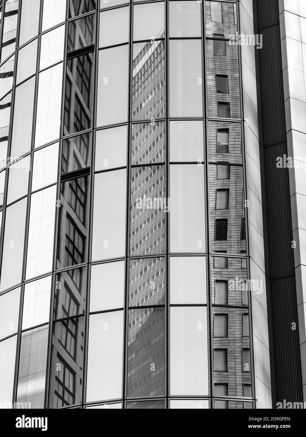 Vertical greyscale facade of a modern office building with glass ...