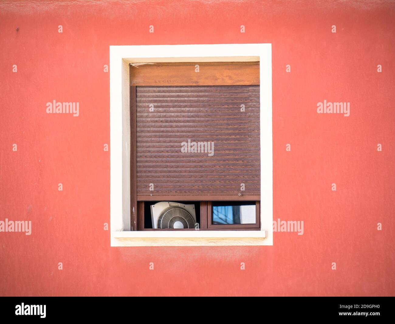 Window with half-closed brown blinds on a red wall Stock Photo - Alamy
