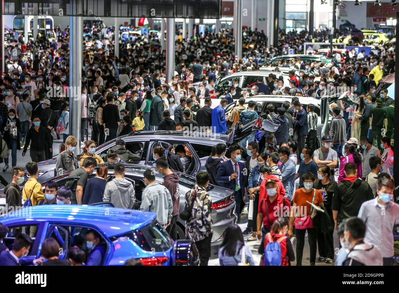 People look at the aotomobiles presented at the 2020 Beijing ...