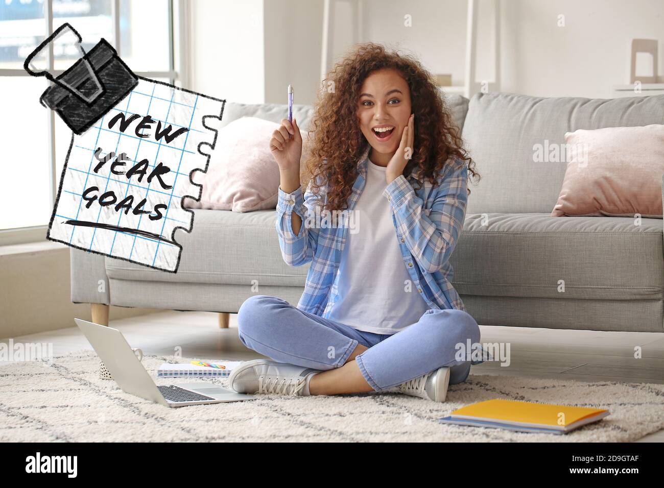 Happy woman with laptop making to do list at home Stock Photo - Alamy