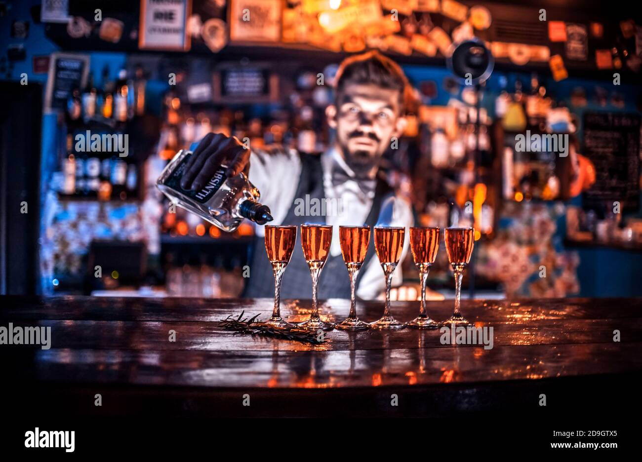 Confident bartender mixes a cocktail behind bar Stock Photo - Alamy