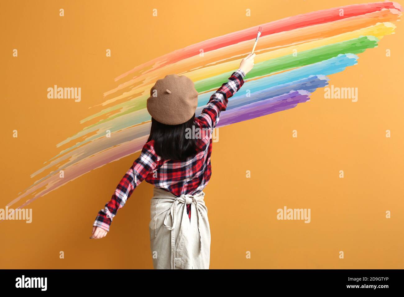 Cute little girl painting rainbow on color background Stock Photo - Alamy