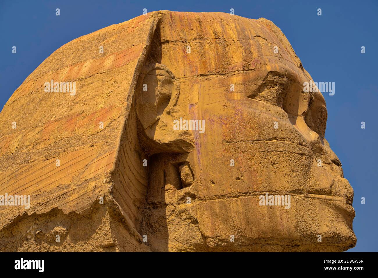 Residues of red pigment are still visible on the face, leading ...