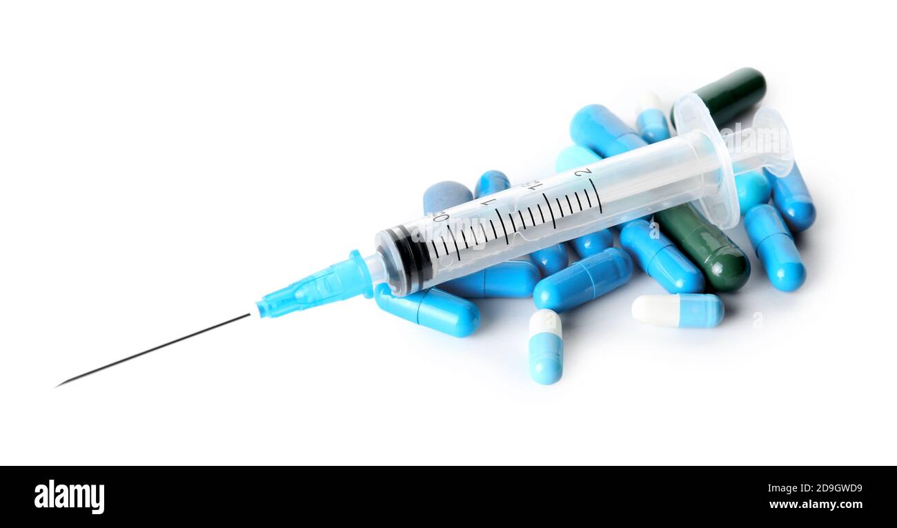 Pills and syringe for injection on white background Stock Photo - Alamy
