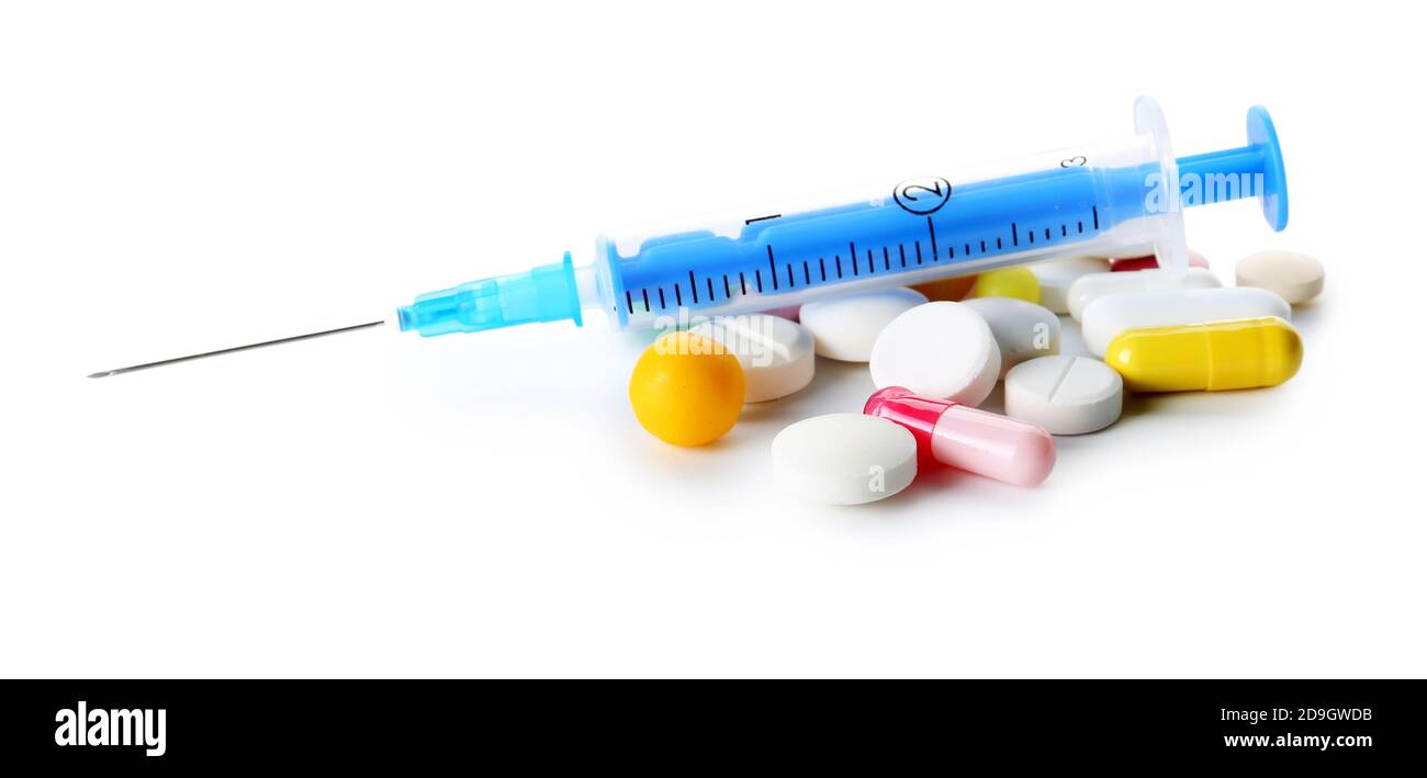Pills and syringe for injection on white background Stock Photo - Alamy