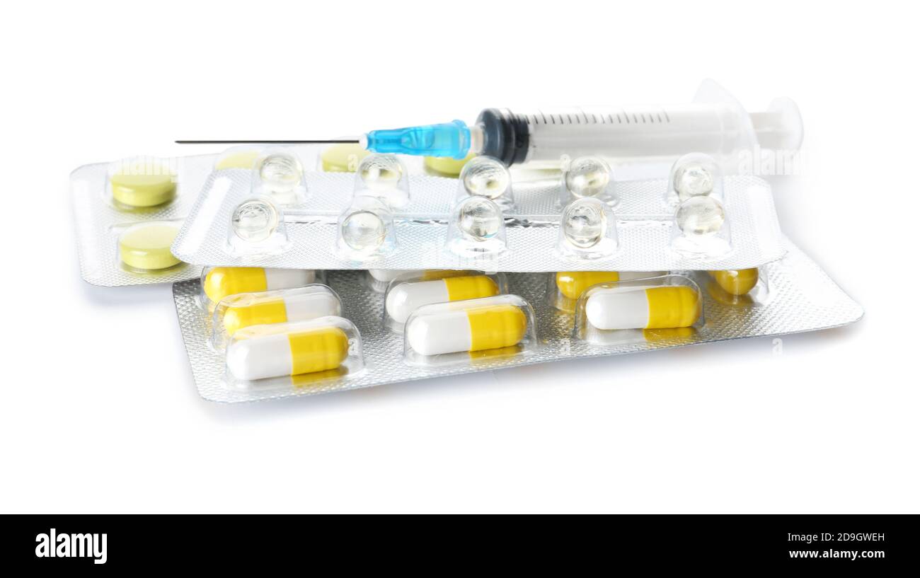 Pills and syringe for injection on white background Stock Photo - Alamy