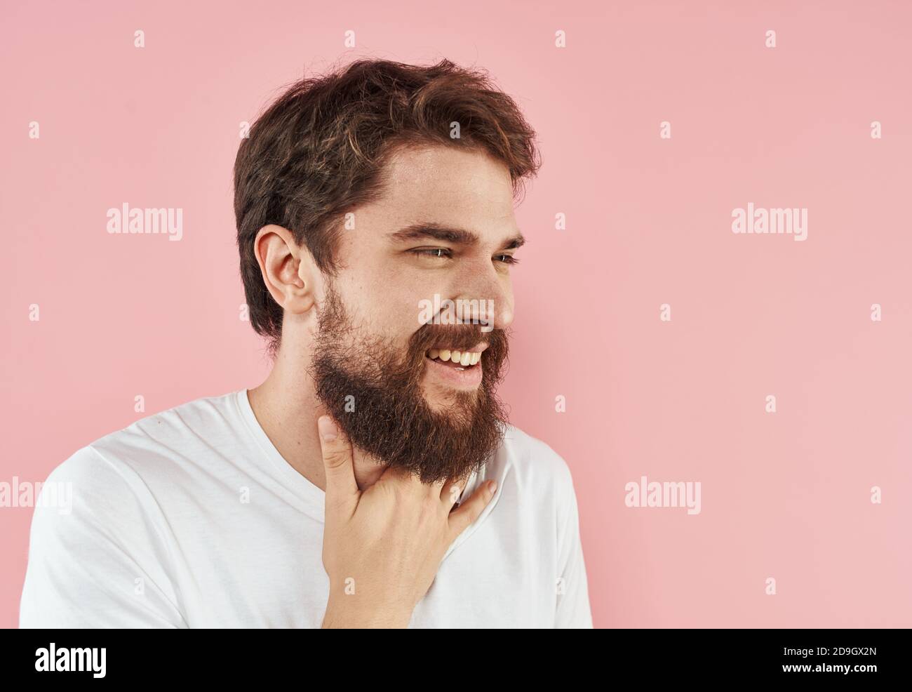 Portrait of happy man joy smile gesturing with hands pink background ...