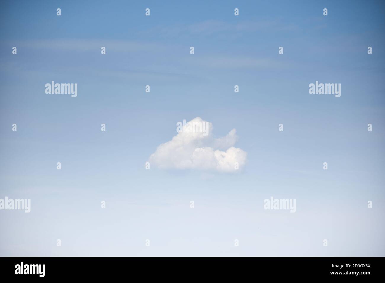 Lone cloud in blue background Stock Photo - Alamy
