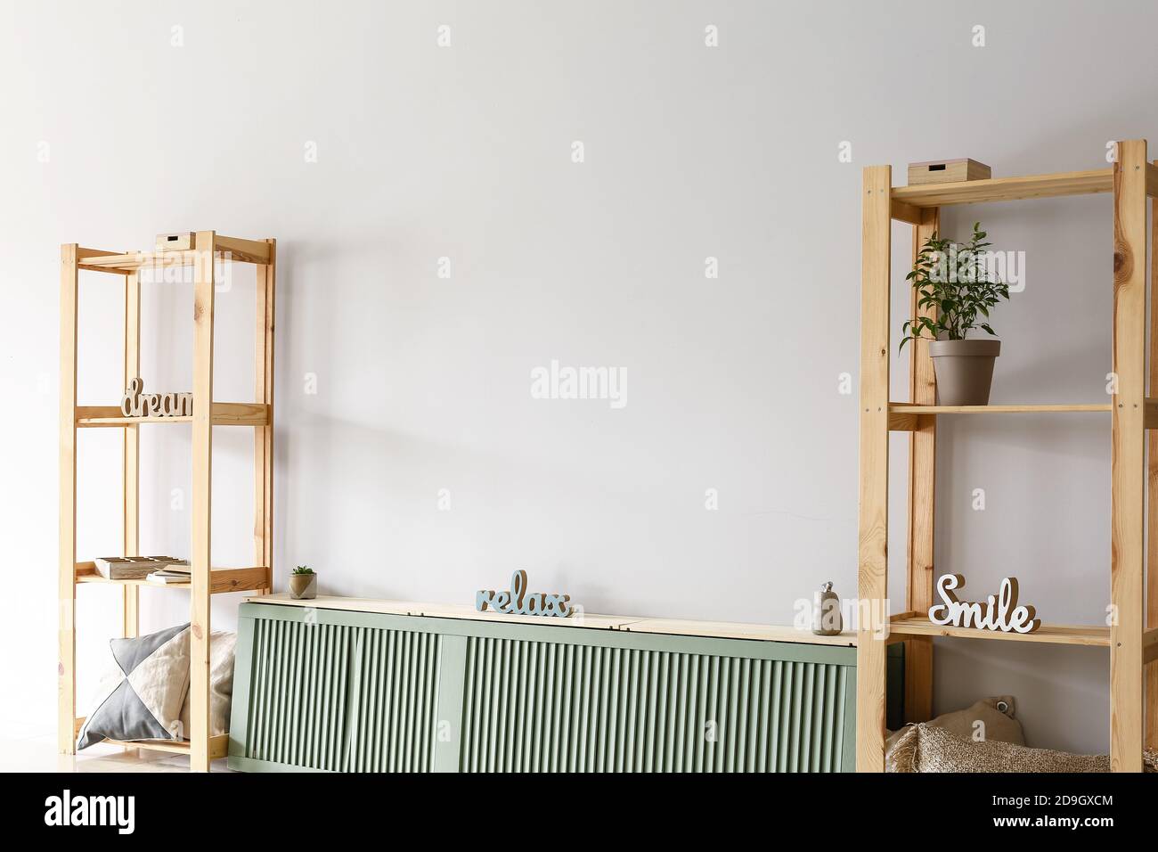 Stylish interior of room with stand and wooden racks Stock Photo - Alamy