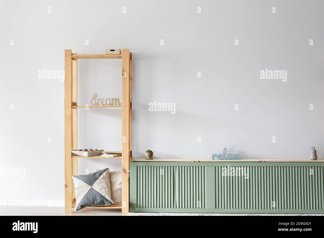 Stylish interior of room with stand and wooden rack Stock Photo - Alamy