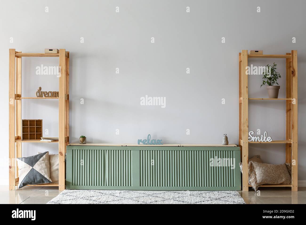 Stylish interior of room with stand and wooden racks Stock Photo - Alamy