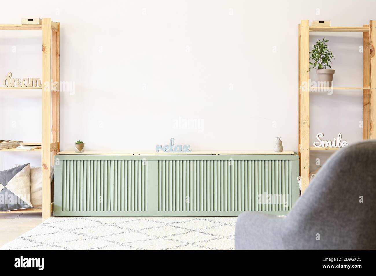 Stylish interior of room with stand and wooden racks Stock Photo - Alamy