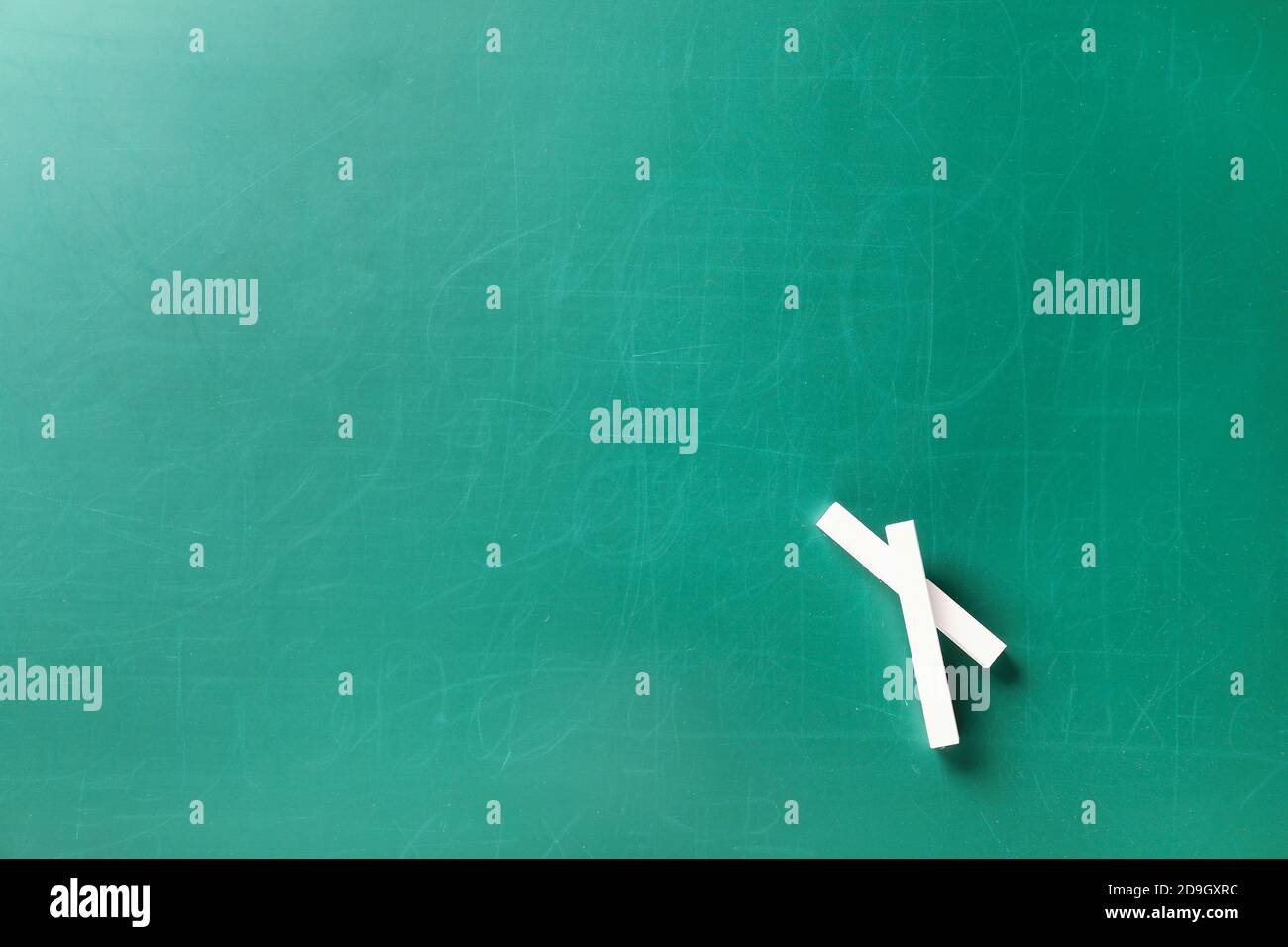Pieces of chalk on blackboard, top view Stock Photo - Alamy