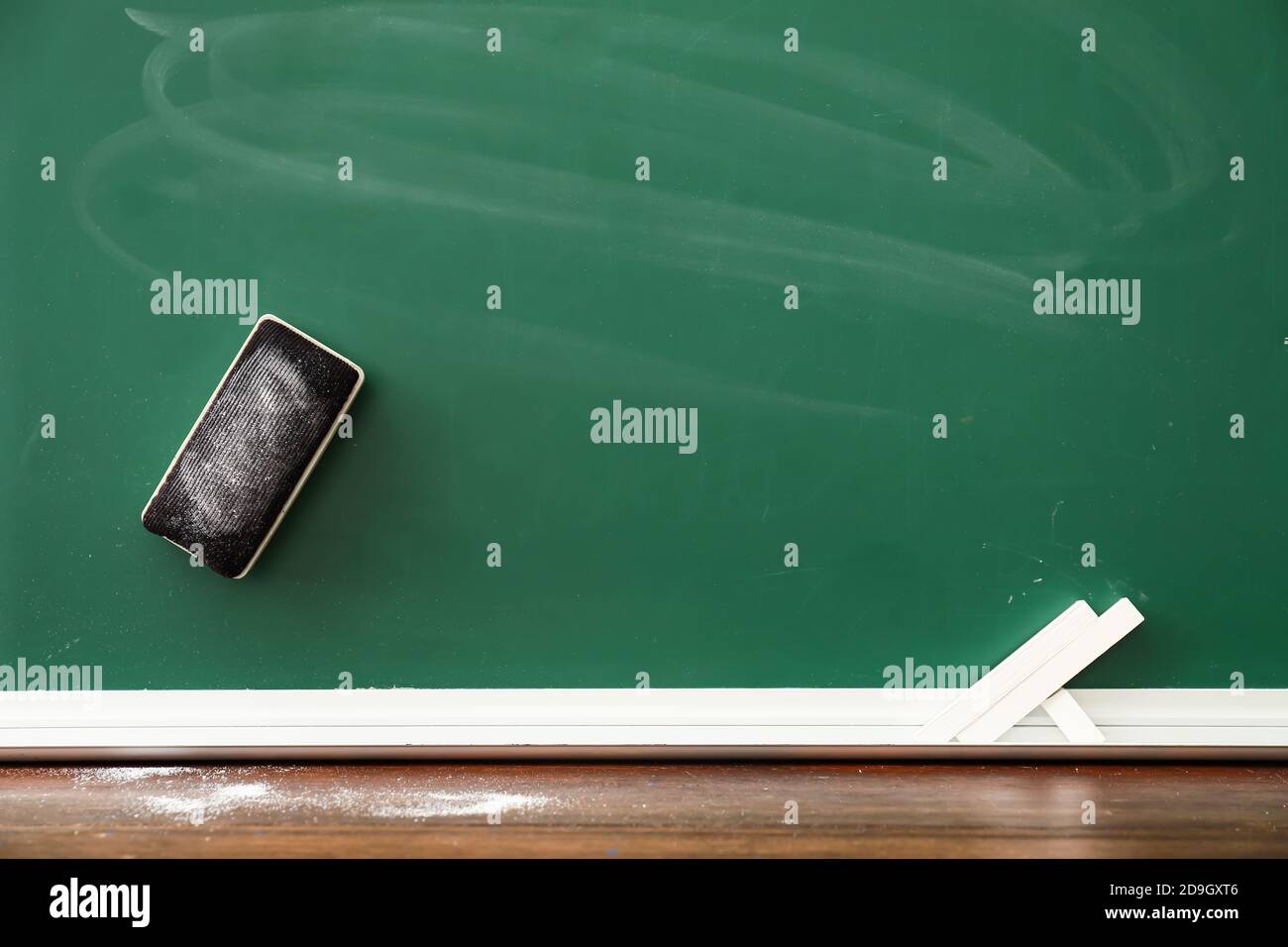 Chalk with sponge and blackboard in classroom Stock Photo - Alamy