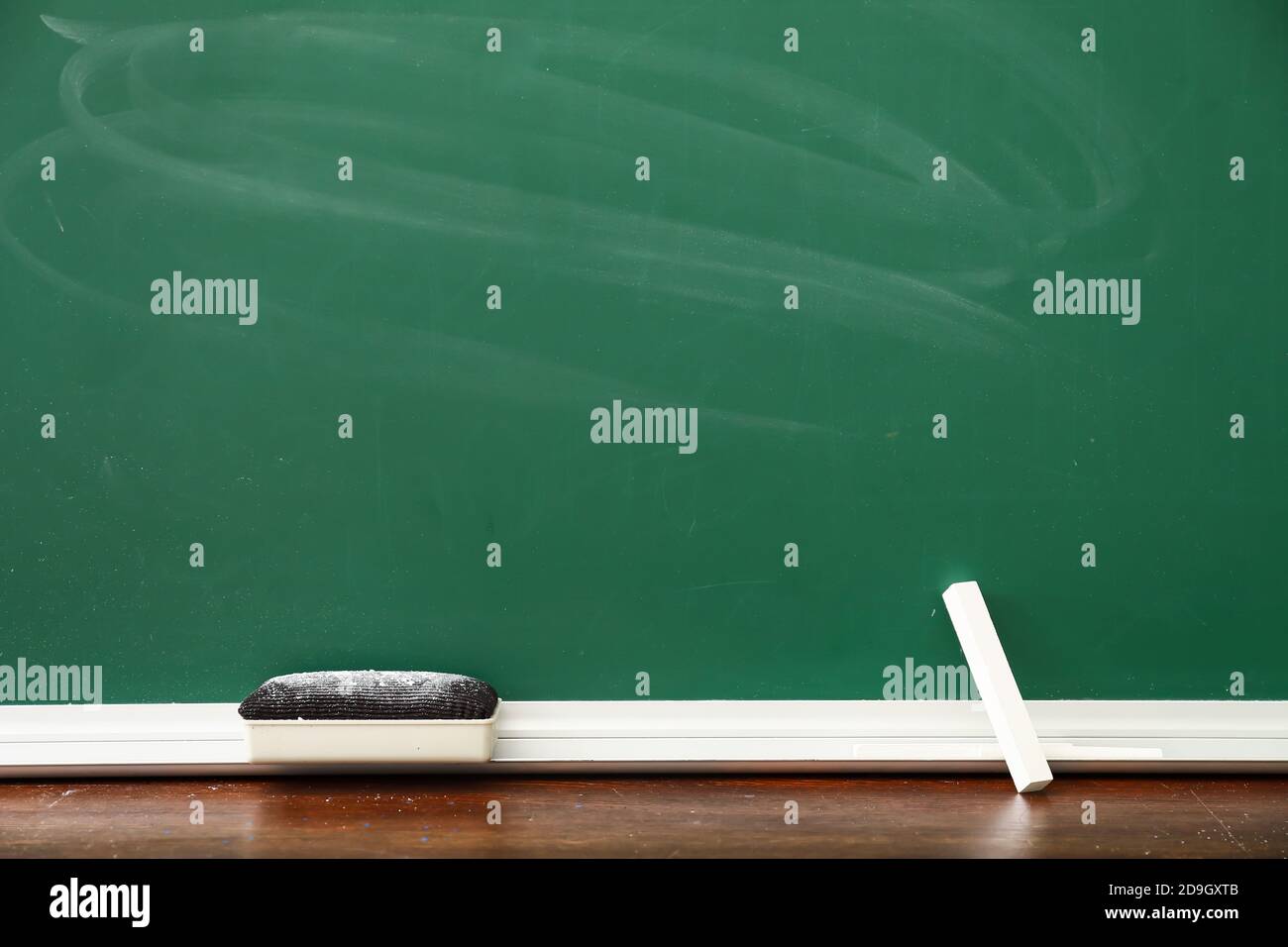 Chalk with sponge and blackboard in classroom Stock Photo - Alamy