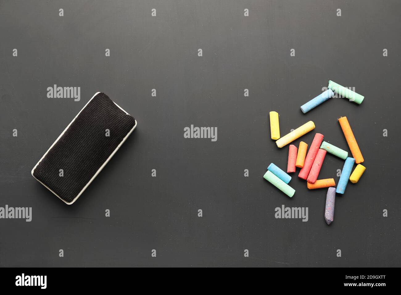 Sponge and pieces of chalk on blackboard, top view Stock Photo - Alamy
