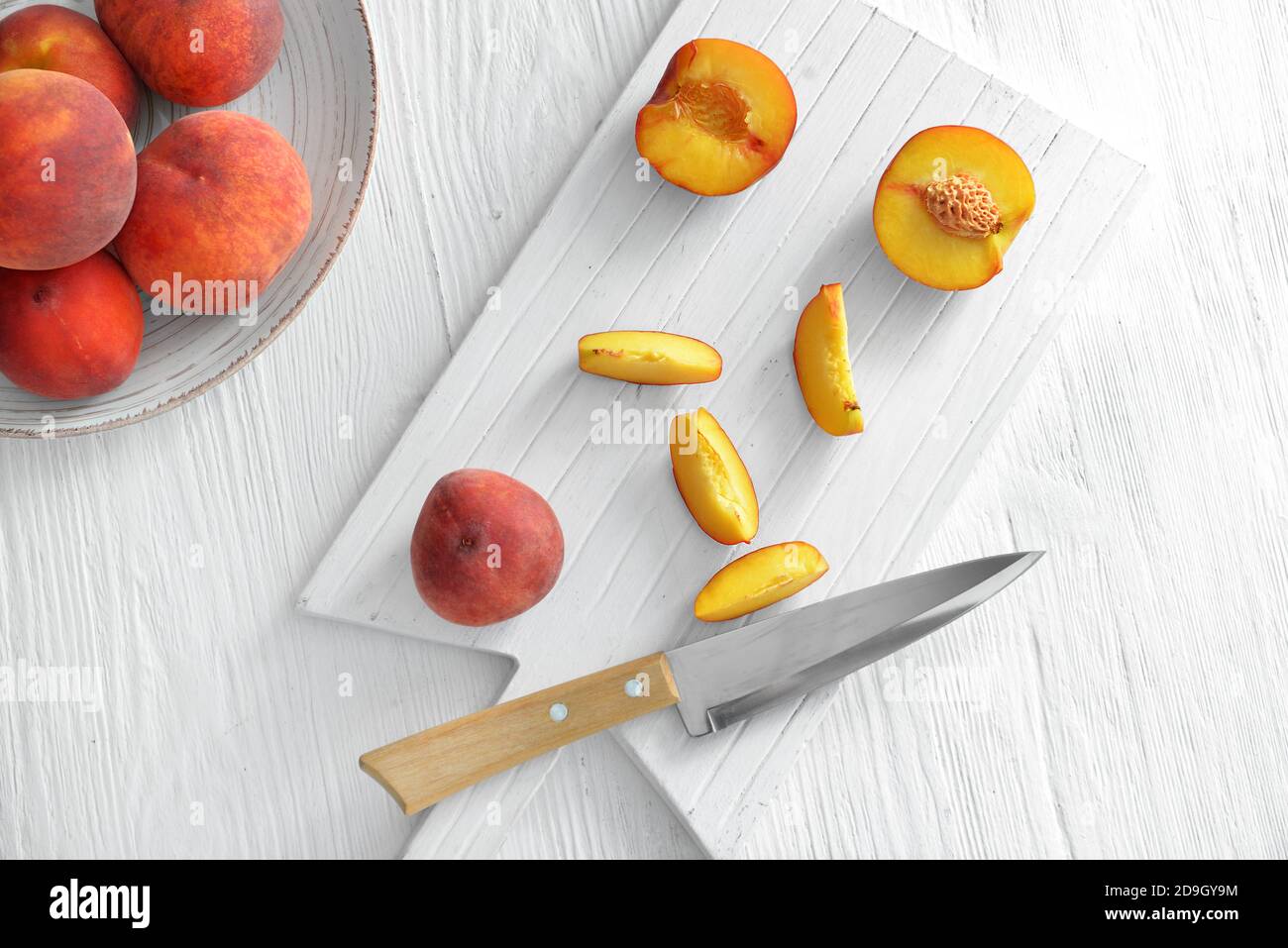 Cutting board with sweet peaches on light background Stock Photo - Alamy