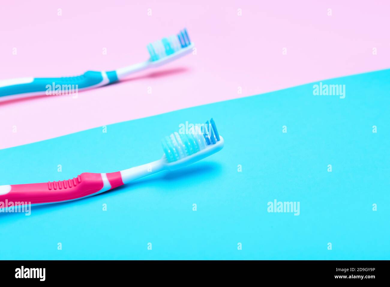 Tooth brushes on color background Stock Photo - Alamy