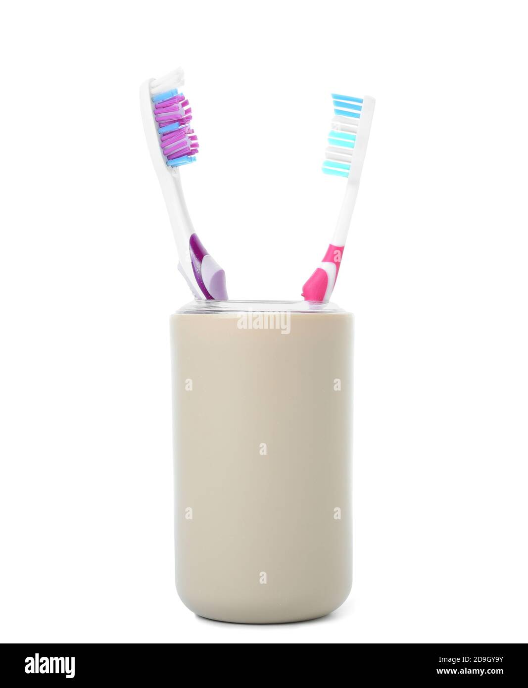 Cup with tooth brushes on white background Stock Photo - Alamy