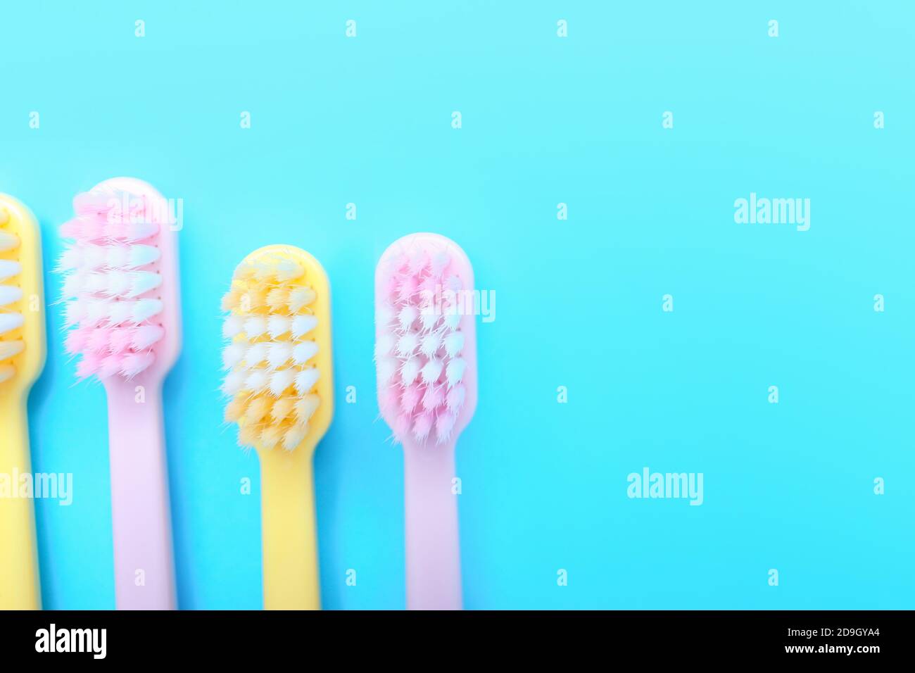 Tooth brushes on color background Stock Photo - Alamy