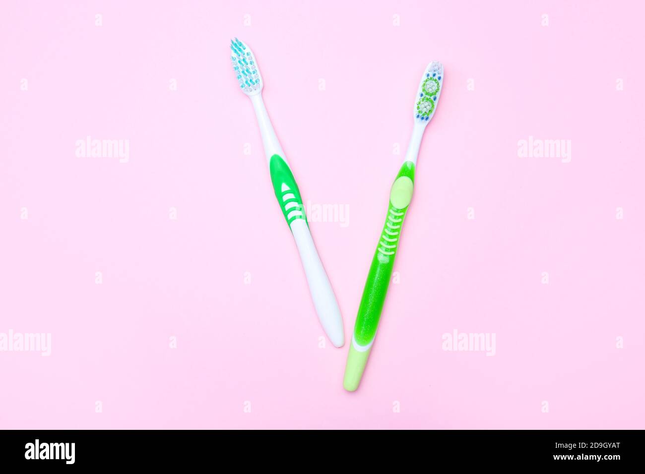 Tooth brushes on color background Stock Photo - Alamy