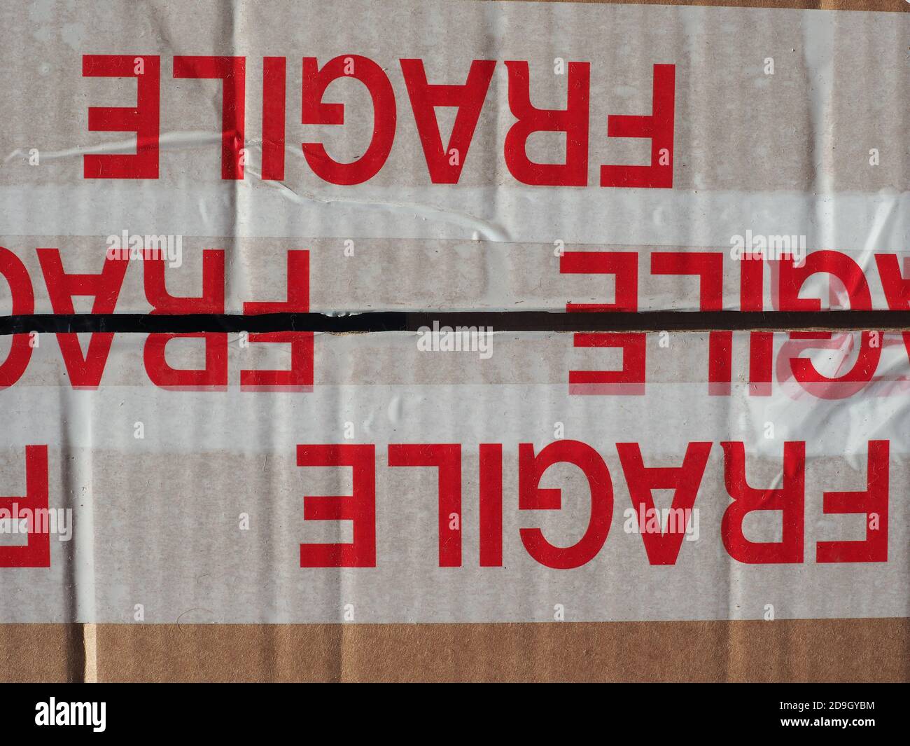 Fragile warning tape on corrugated cardboard box Stock Photo - Alamy