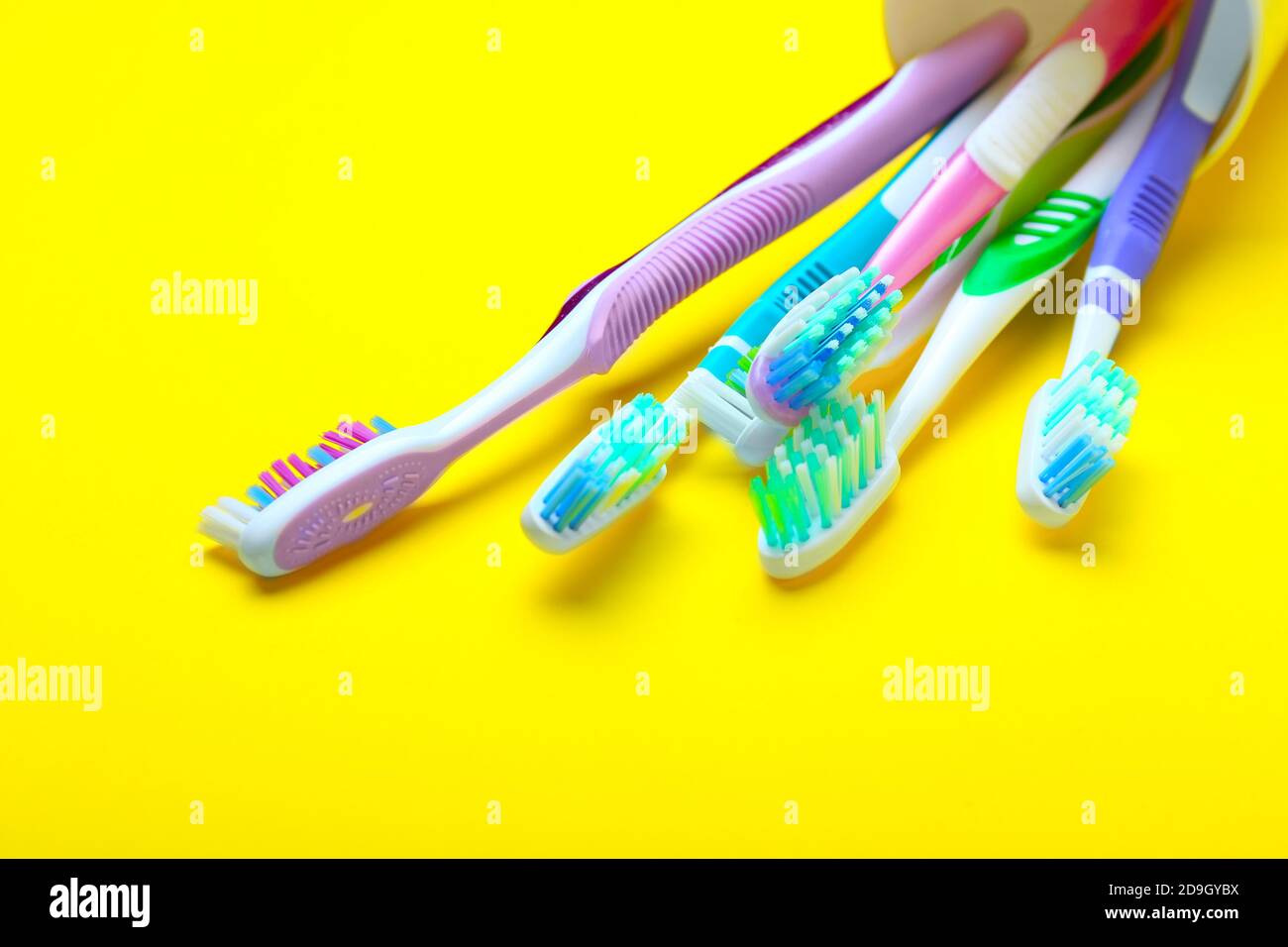 Tooth brushes on color background Stock Photo - Alamy