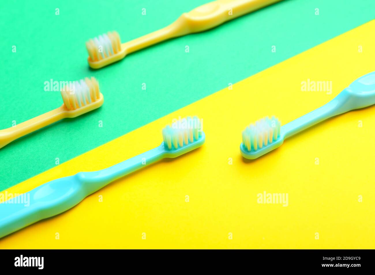 Tooth brushes on color background Stock Photo - Alamy