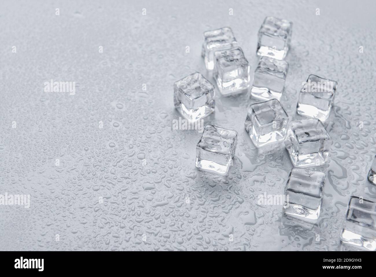 Ice cubes on grey background Stock Photo - Alamy