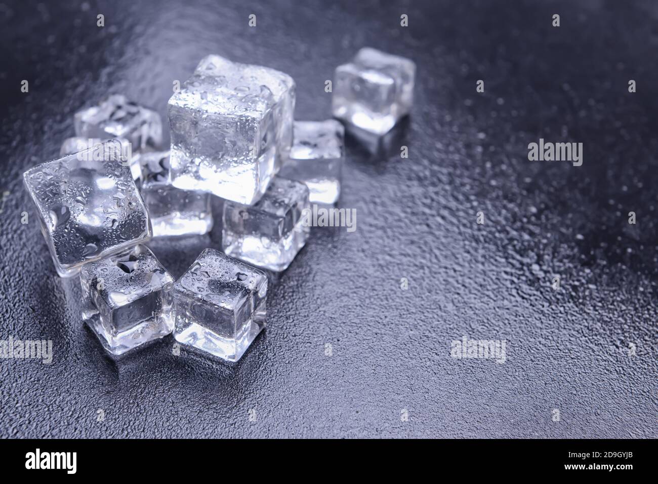 Ice cubes on dark background Stock Photo - Alamy