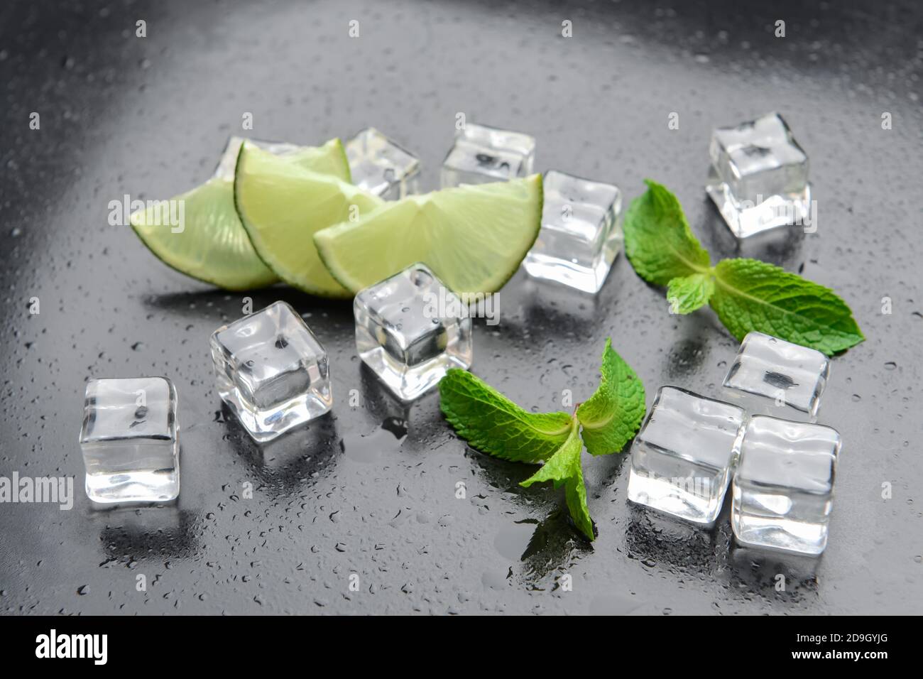 Ice cubes, lime and mint on dark background Stock Photo - Alamy