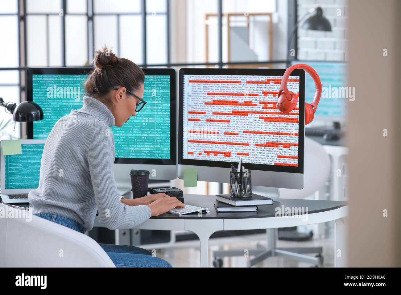 Female programmer working in office Stock Photo - Alamy