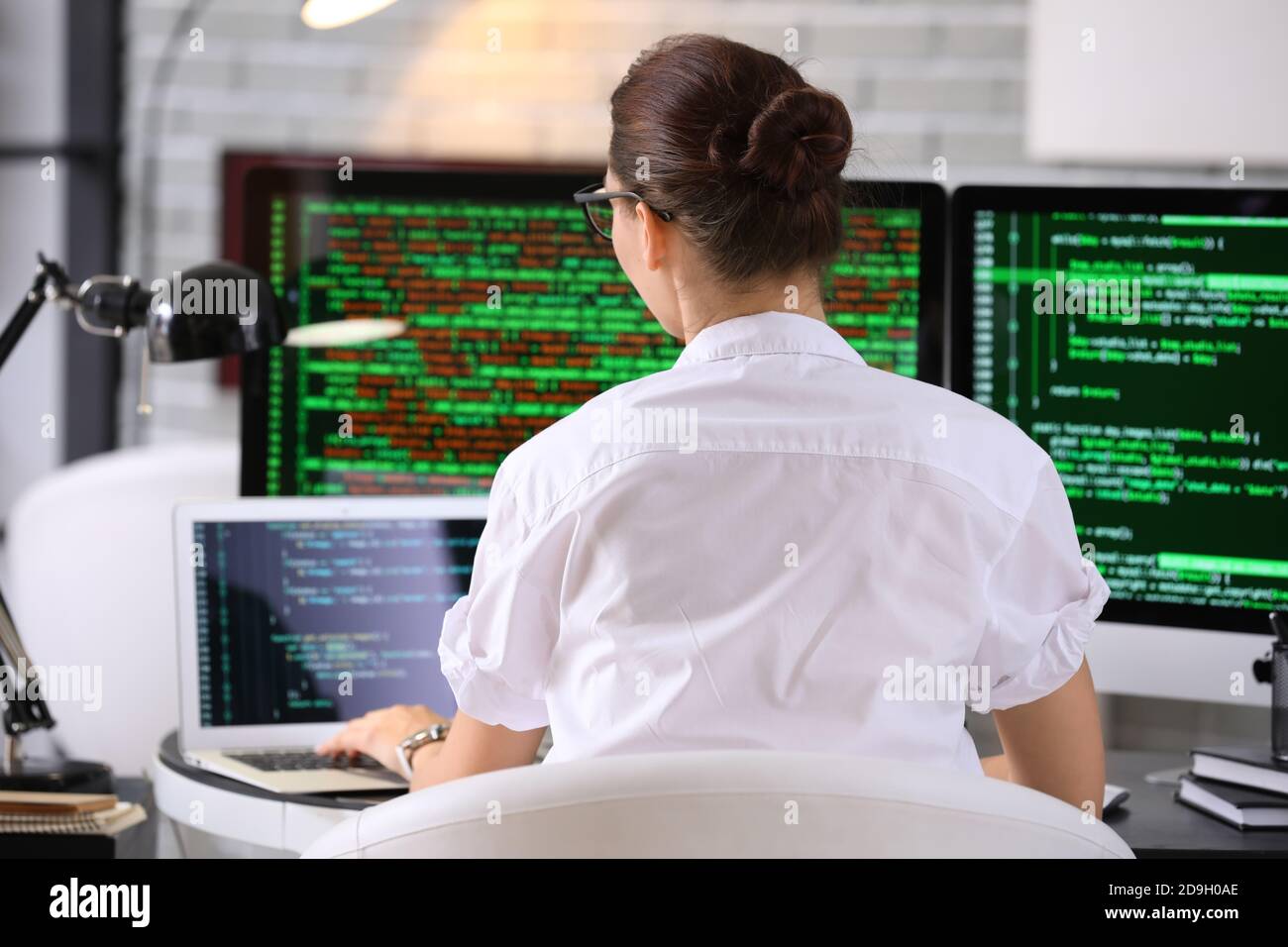 Female programmer working in office Stock Photo - Alamy