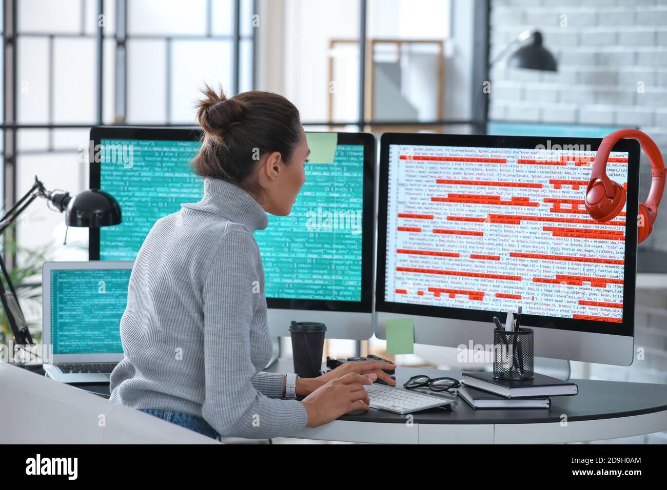 Female programmer working in office Stock Photo - Alamy