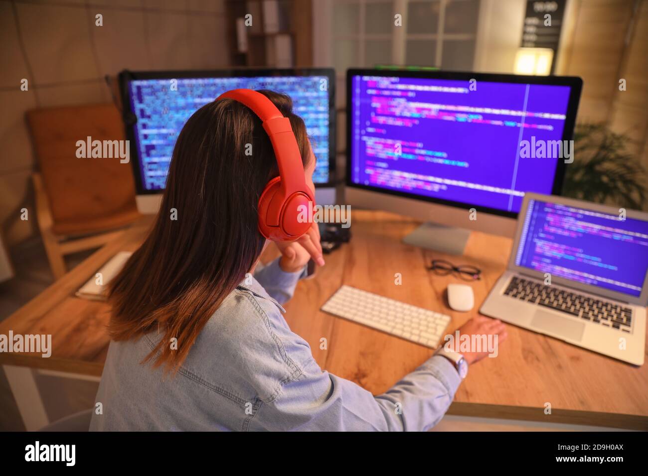 Female programmer working in office at night Stock Photo - Alamy