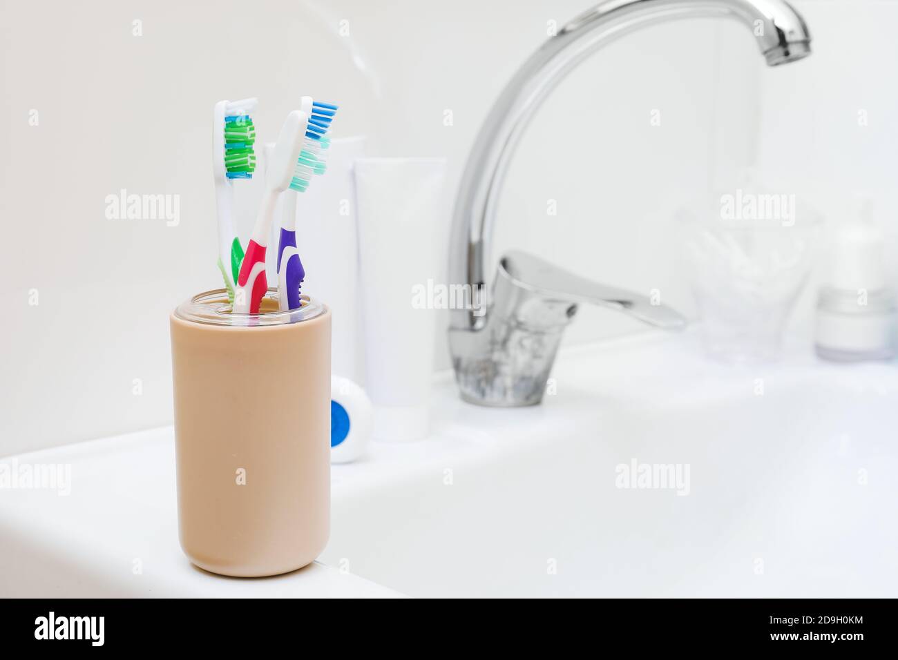 Tooth brushes in cup hi-res stock photography and images - Alamy