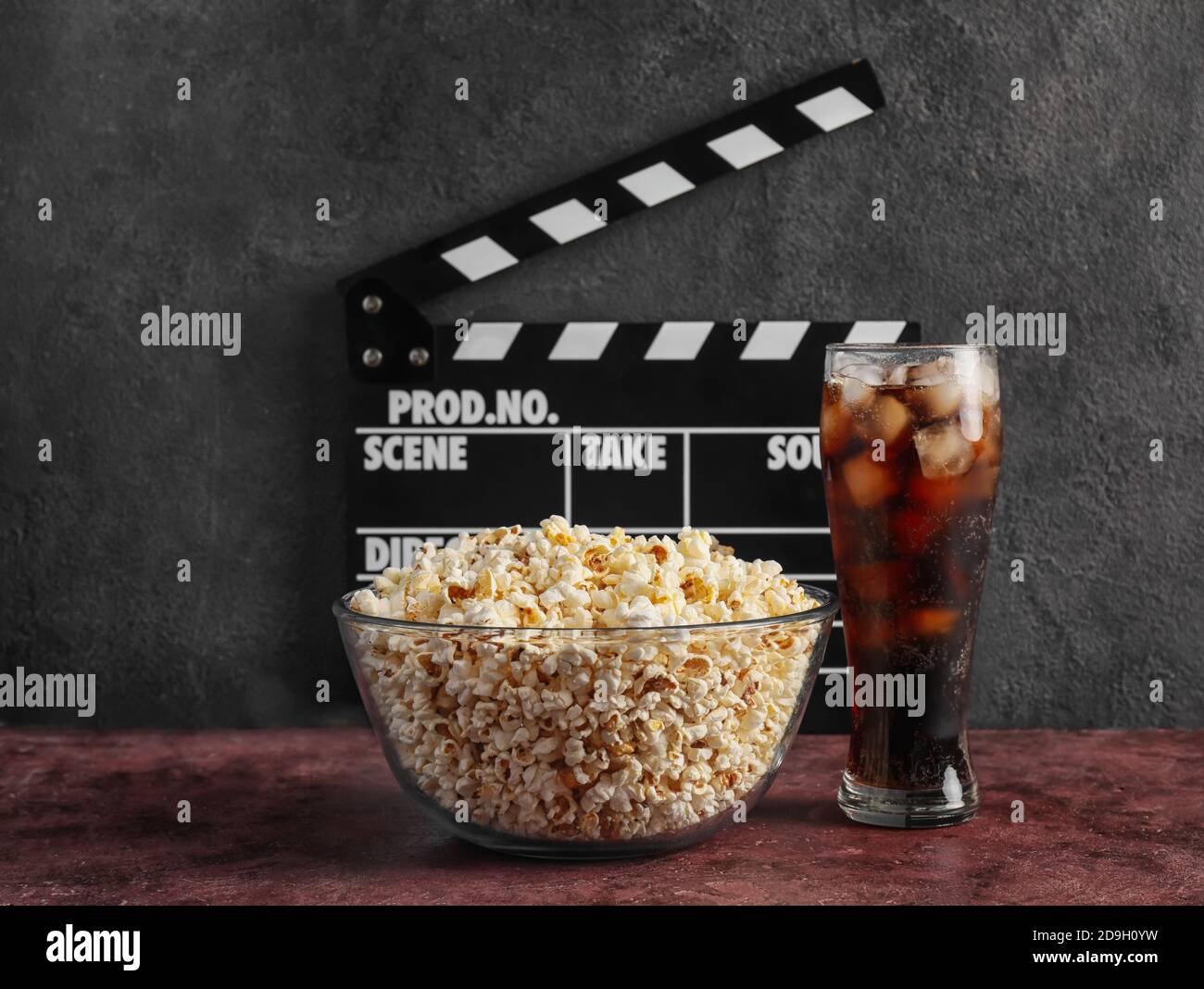 Popcorn, cola and movie clapper on dark background Stock Photo - Alamy